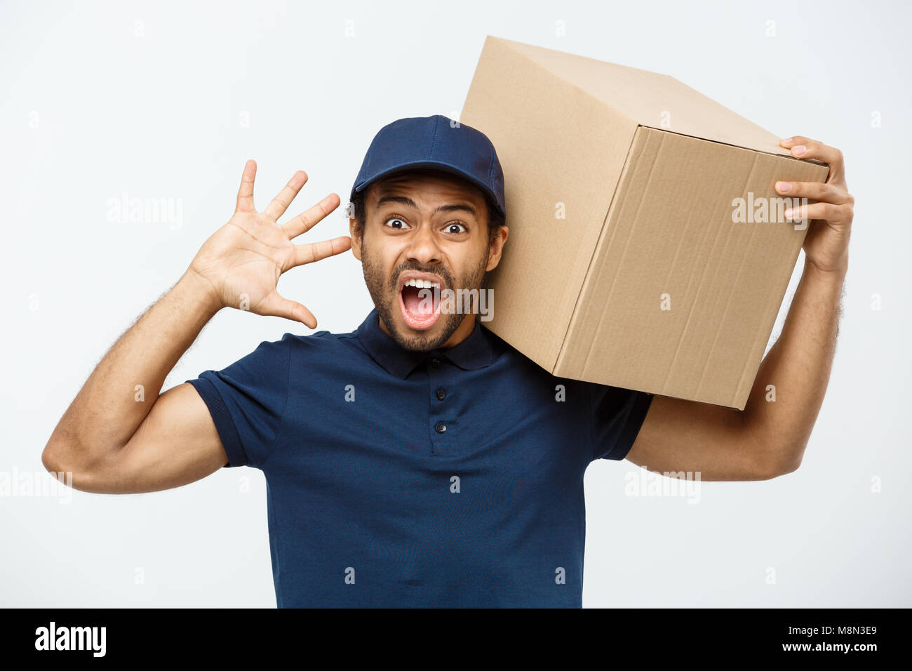 Delivery Concept - Portrait of Serious African American delivery man ...