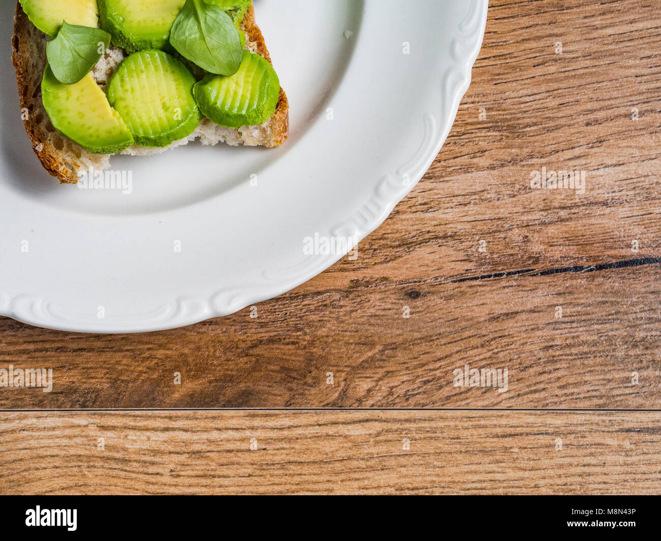 Avocado toast in a plate on wood background Stock Photo - Alamy