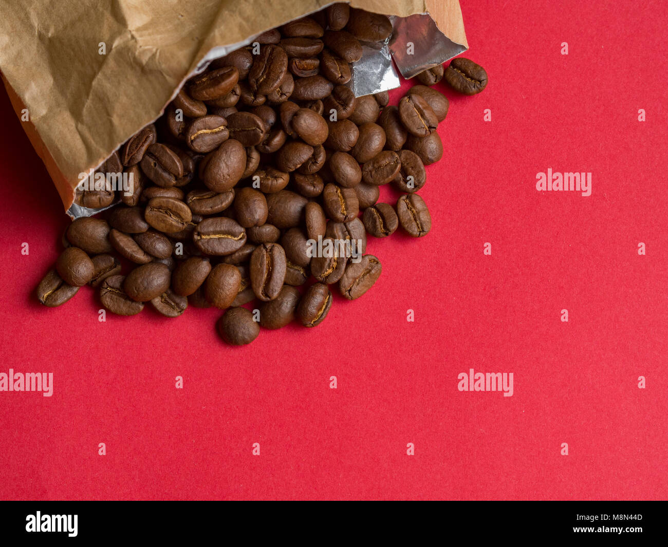 Coffe beans package on red background Stock Photo - Alamy