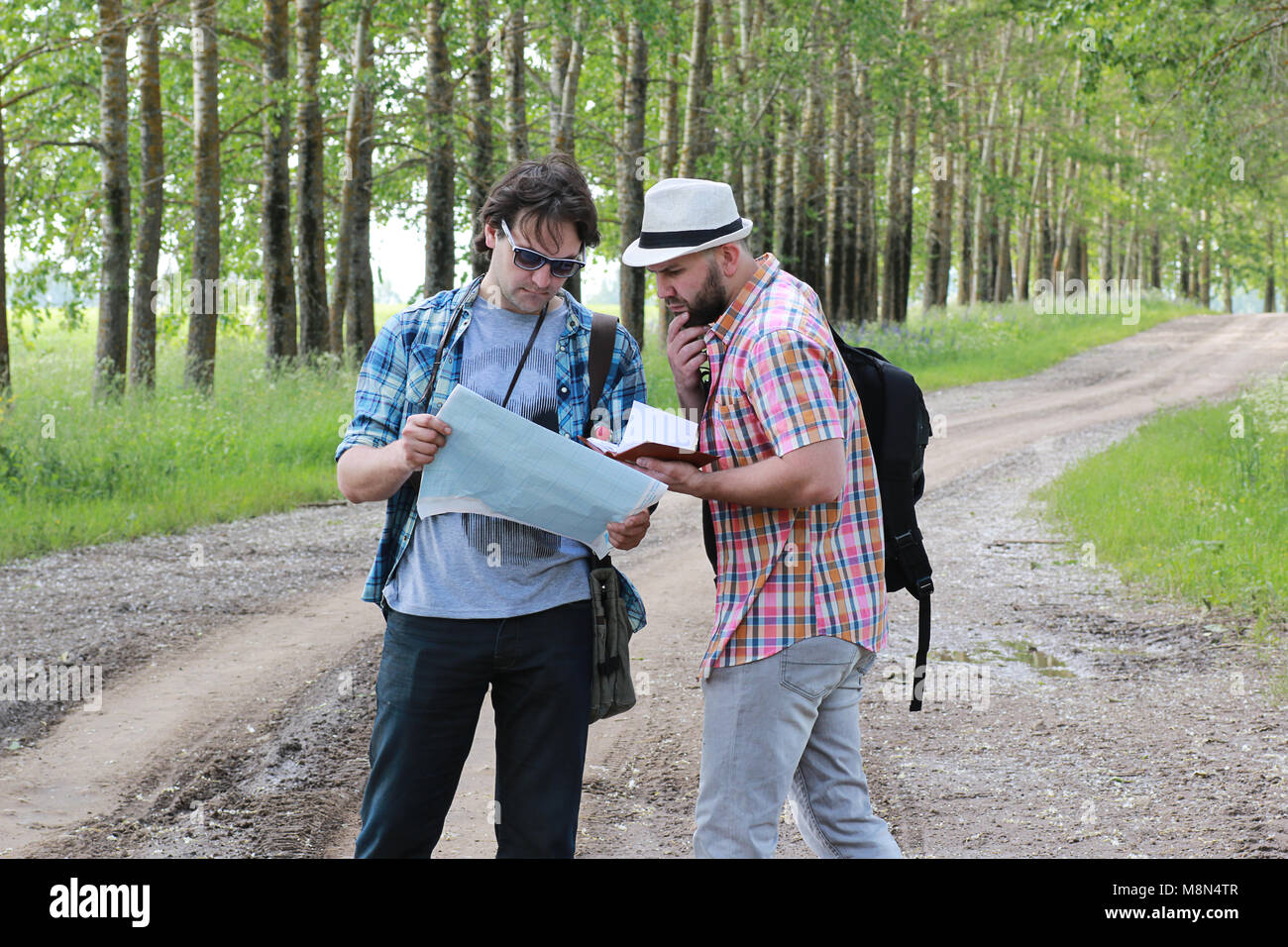 A young man looks at a map Stock Photo - Alamy