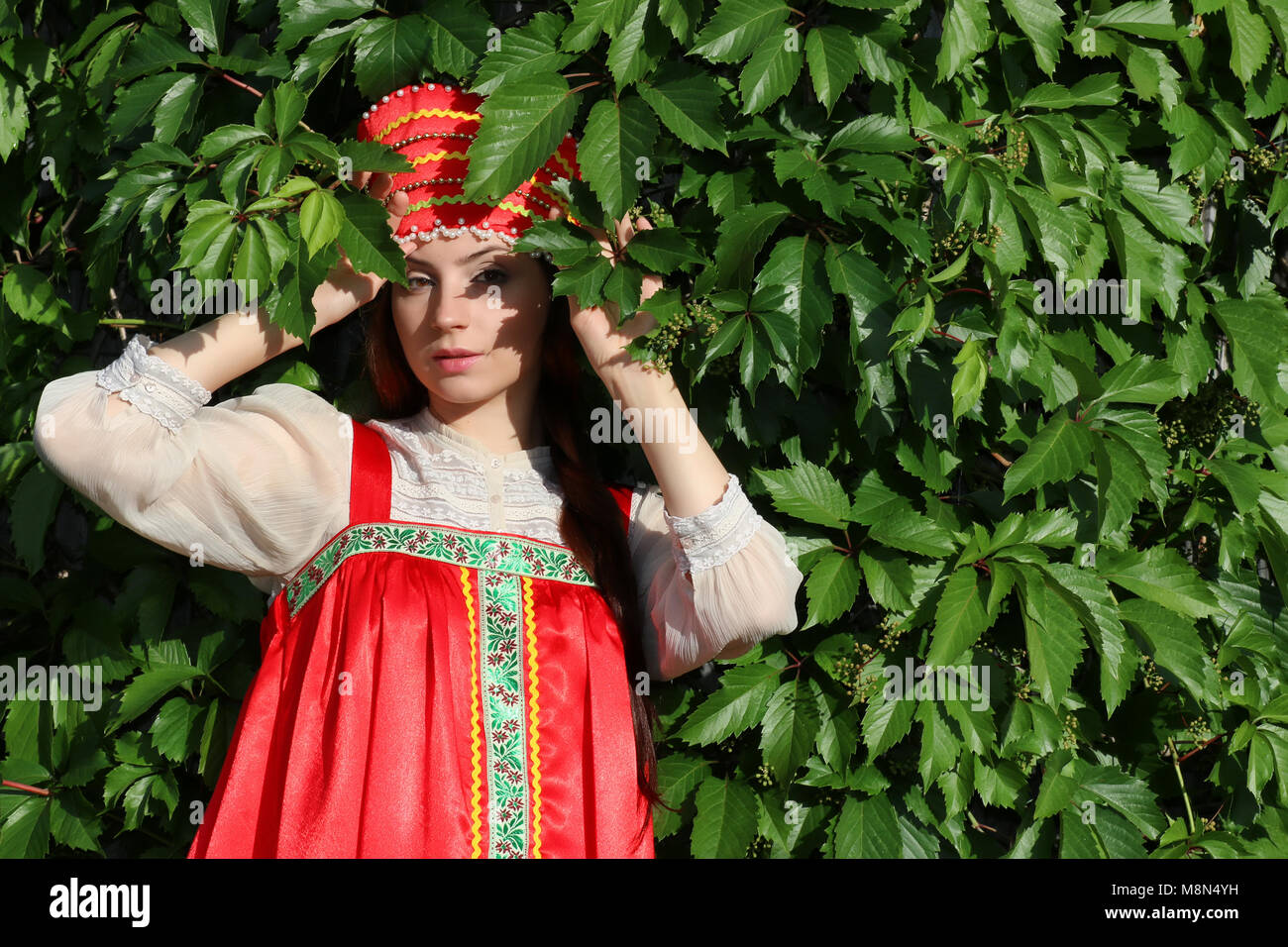 Slav in traditional dress ivy wall tree Stock Photo - Alamy