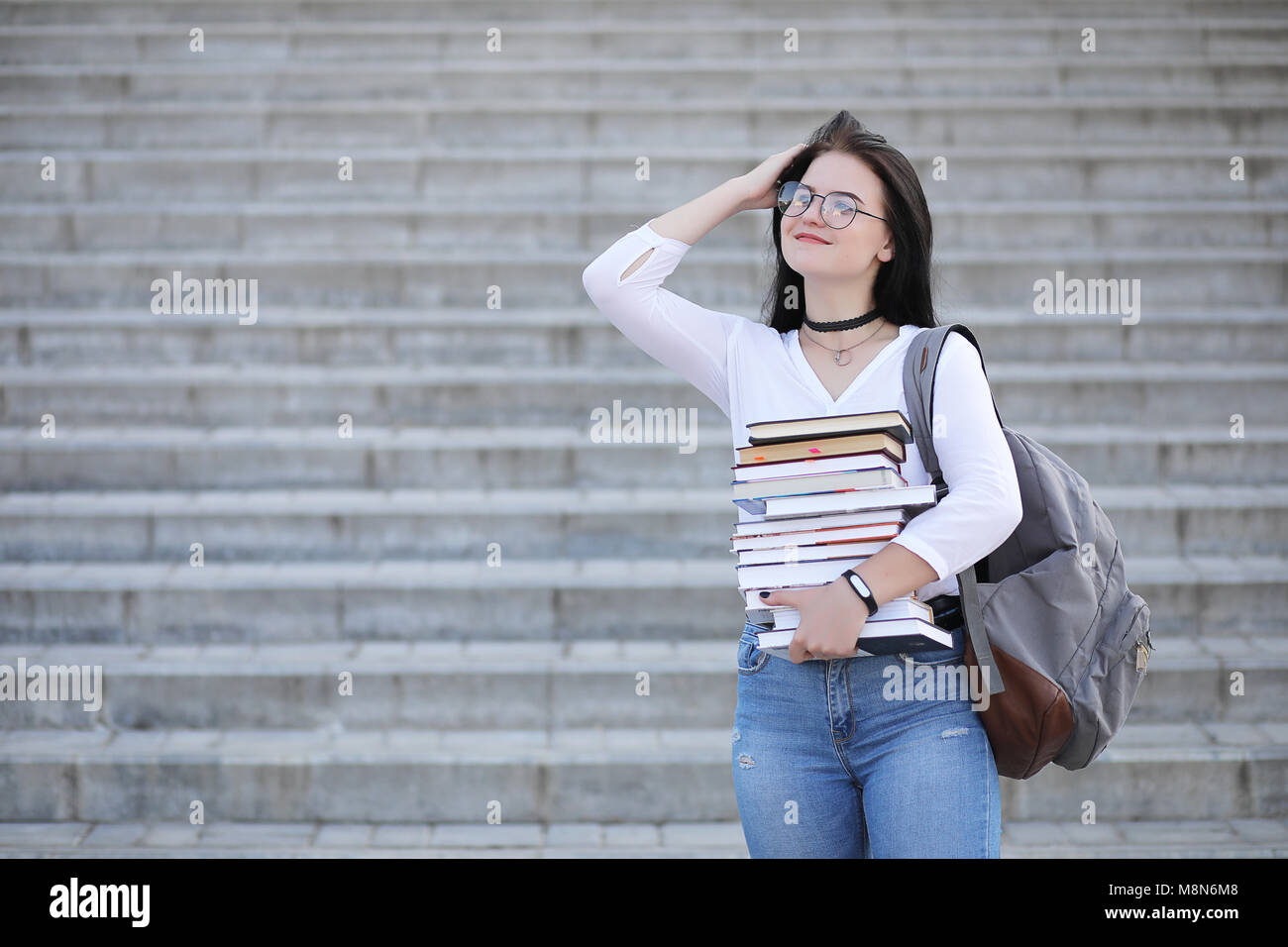 Girl student on the street with books Stock Photo - Alamy
