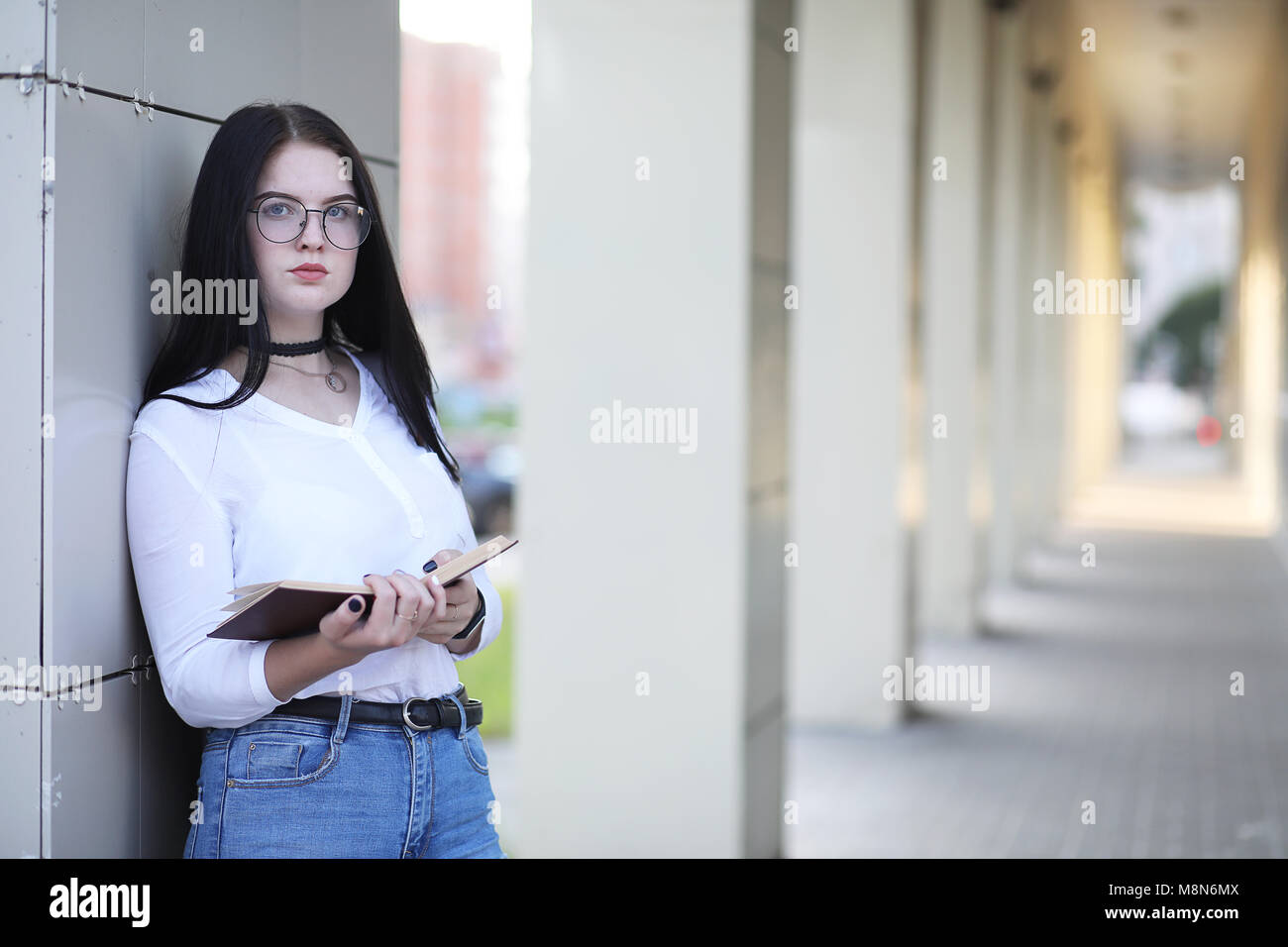 Girl student on the street with books Stock Photo - Alamy