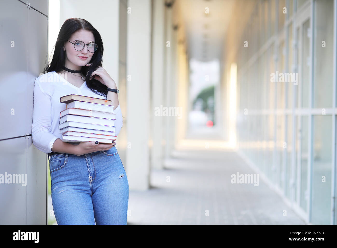 Girl student on the street with books Stock Photo - Alamy
