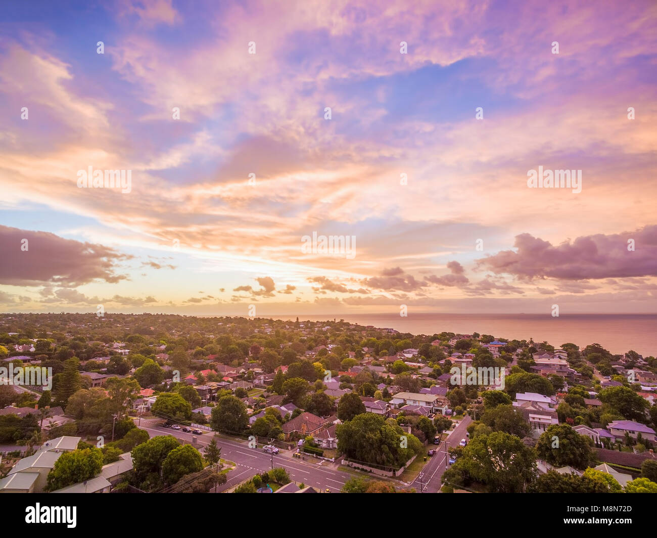 Aerial view of houses near coastline at beautiful sunset Stock Photo ...