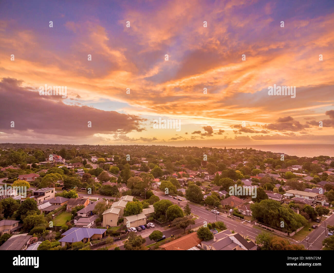 Aerial view of glowing sunset over suburban area Stock Photo - Alamy