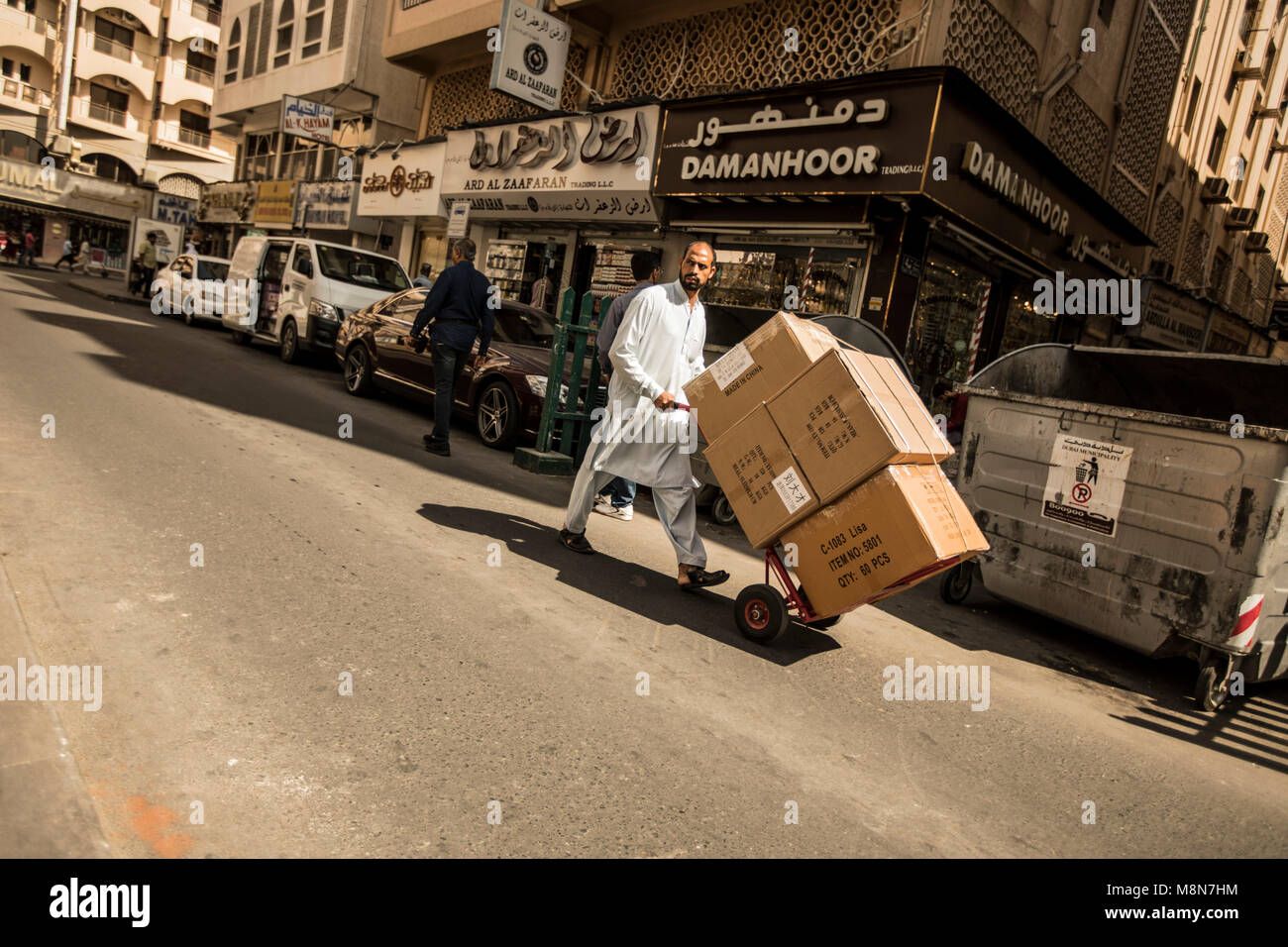 A men walking down the street of Dubai's old district Al Ras, Deira ...