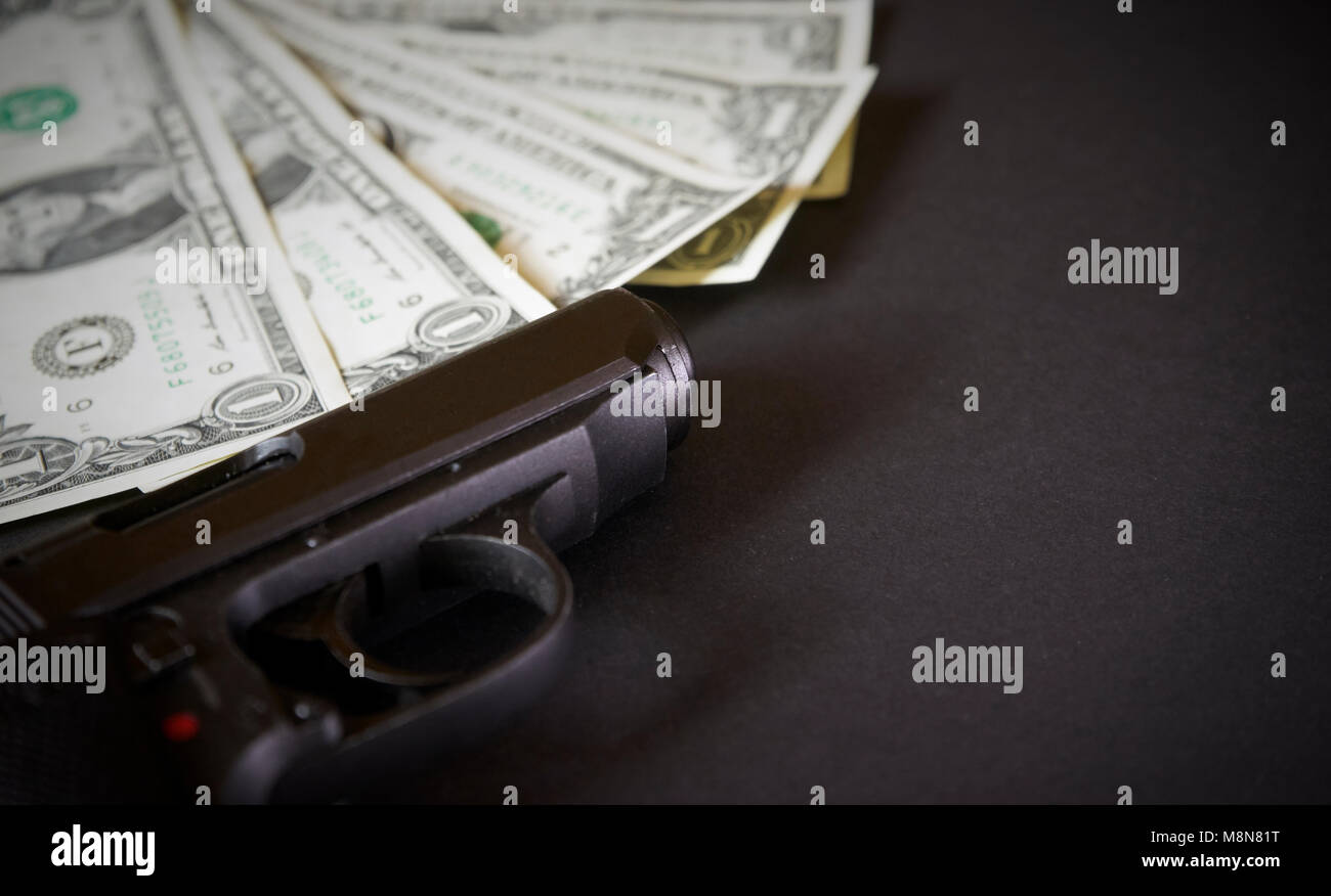 Gun and money concept Stock Photo - Alamy