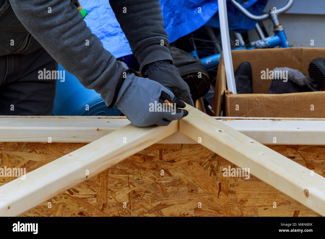 Closeup of a carpenter's hands wood battens of modern building Stock ...