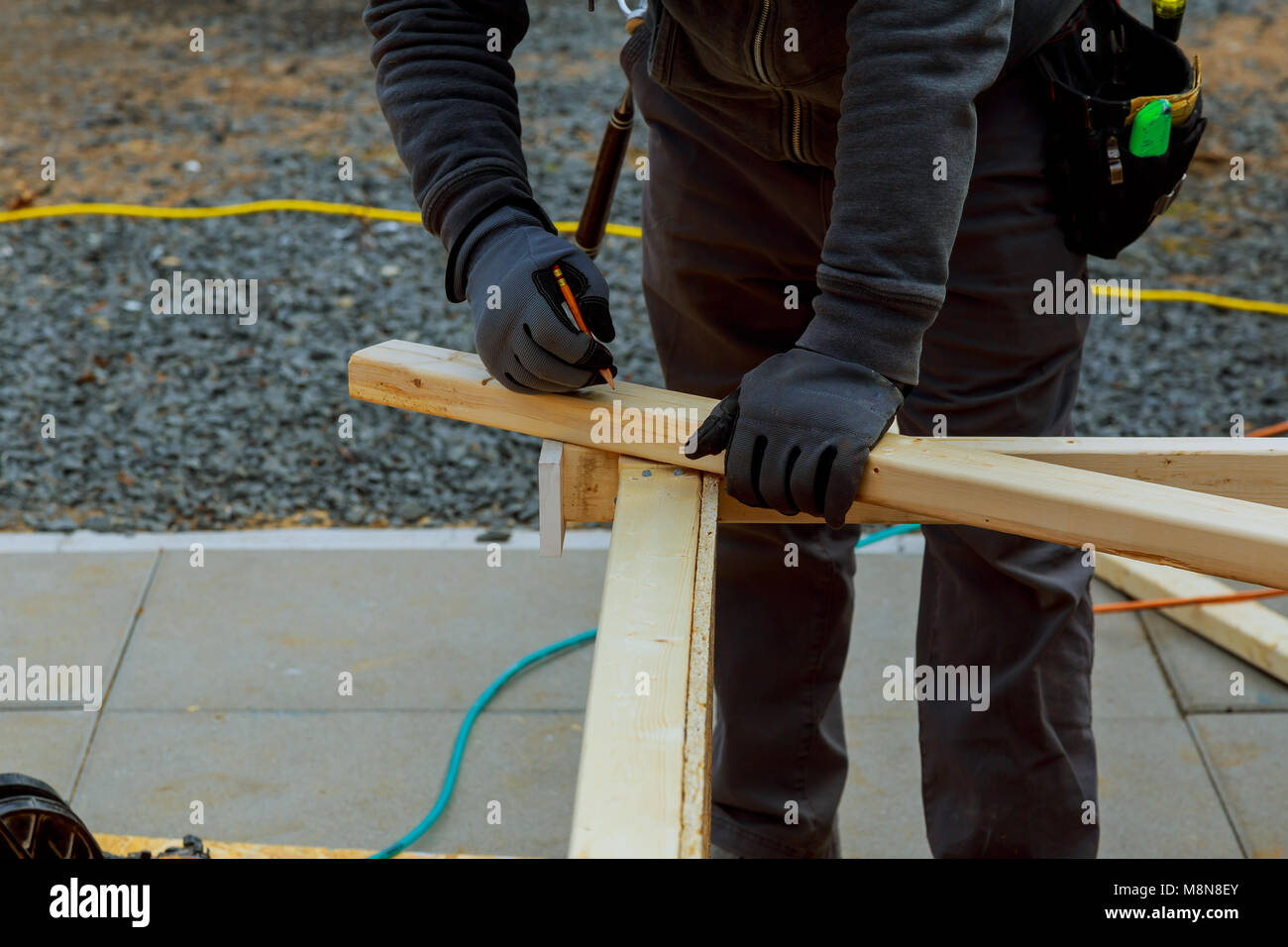 builder at work with wooden construction Closeup of a carpenter's hands ...