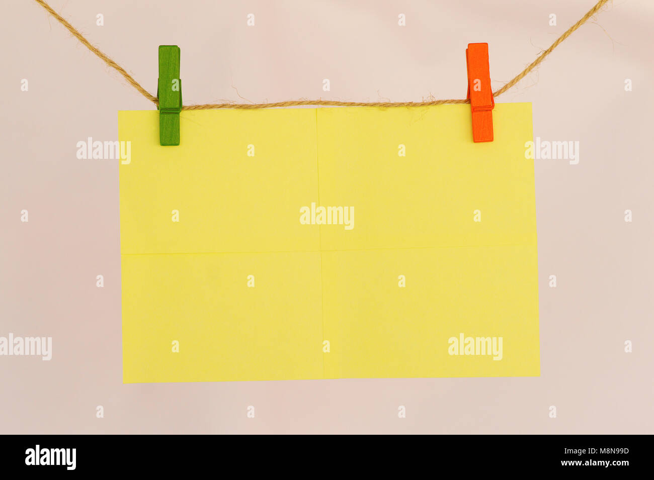 Blank sticky notes hanging with cloth pins on clothes line close view ...