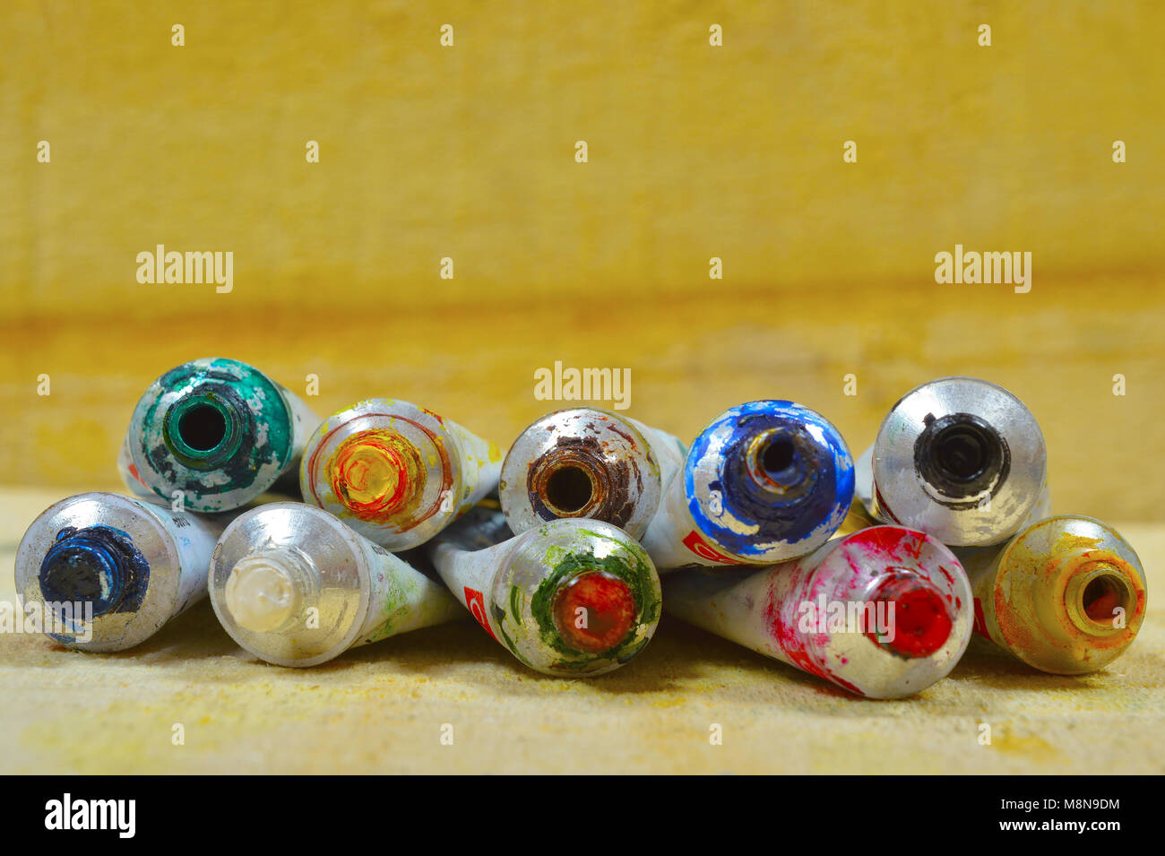 Close view of color tubes isolated on a wooden background Stock Photo ...