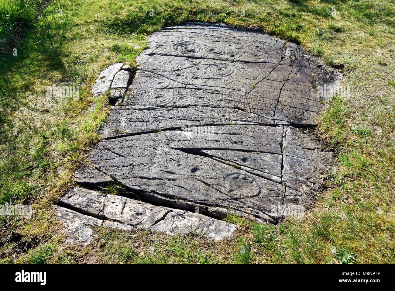 Cup and ring mark marks prehistoric Neolithic rock art on natural rock ...