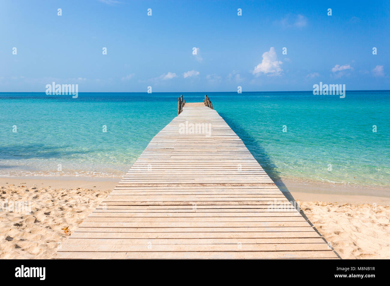 Wooden bridge on the tropical beach and blue sky Stock Photo - Alamy