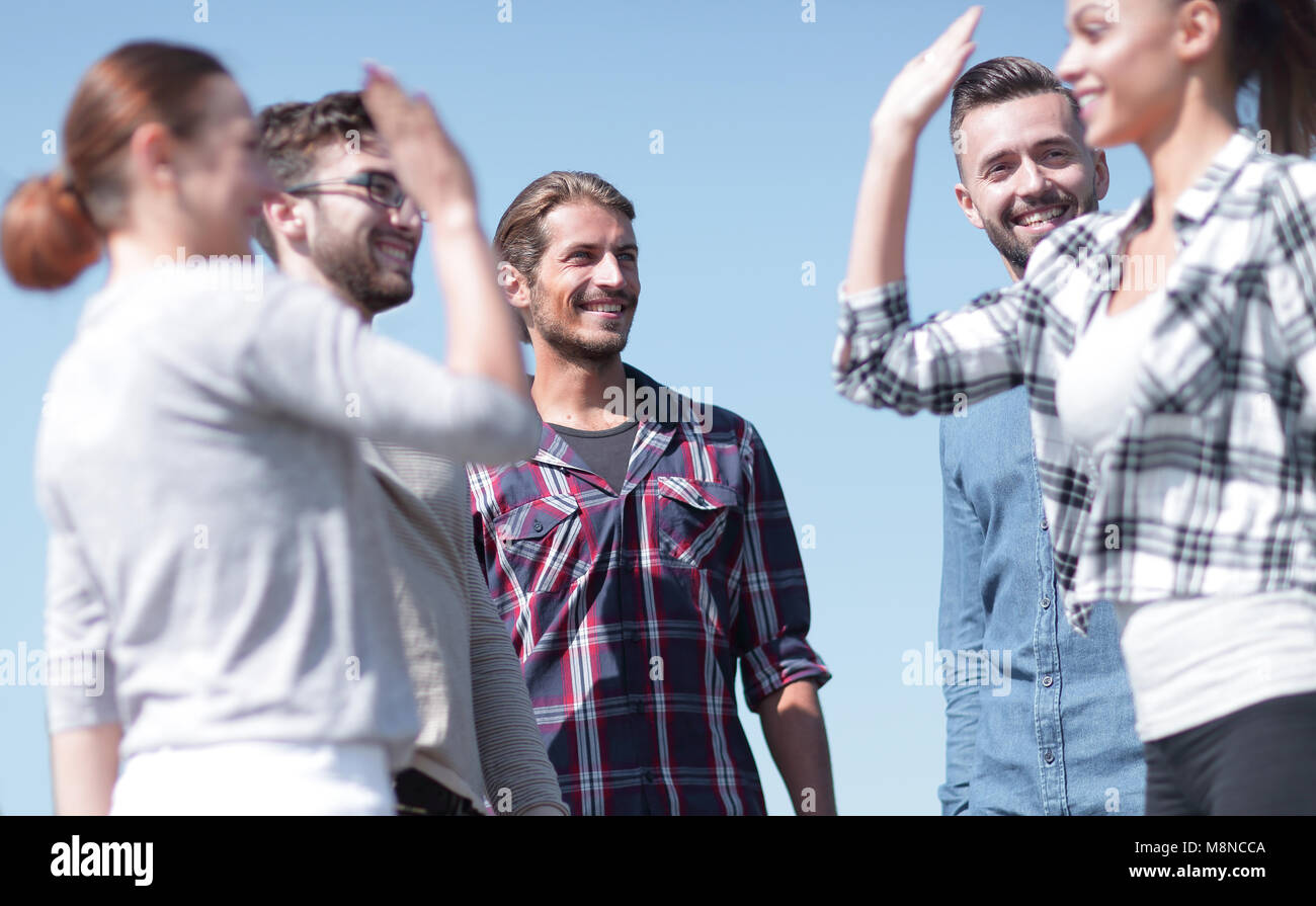 friends students giving each other a high five Stock Photo - Alamy