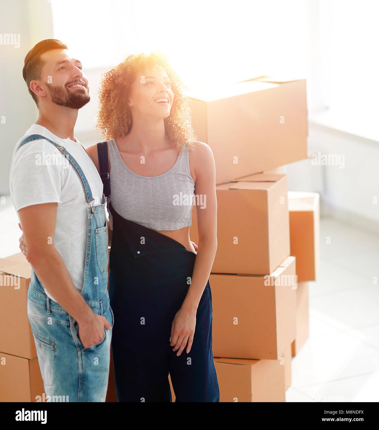 married couple standing in new apartment Stock Photo - Alamy