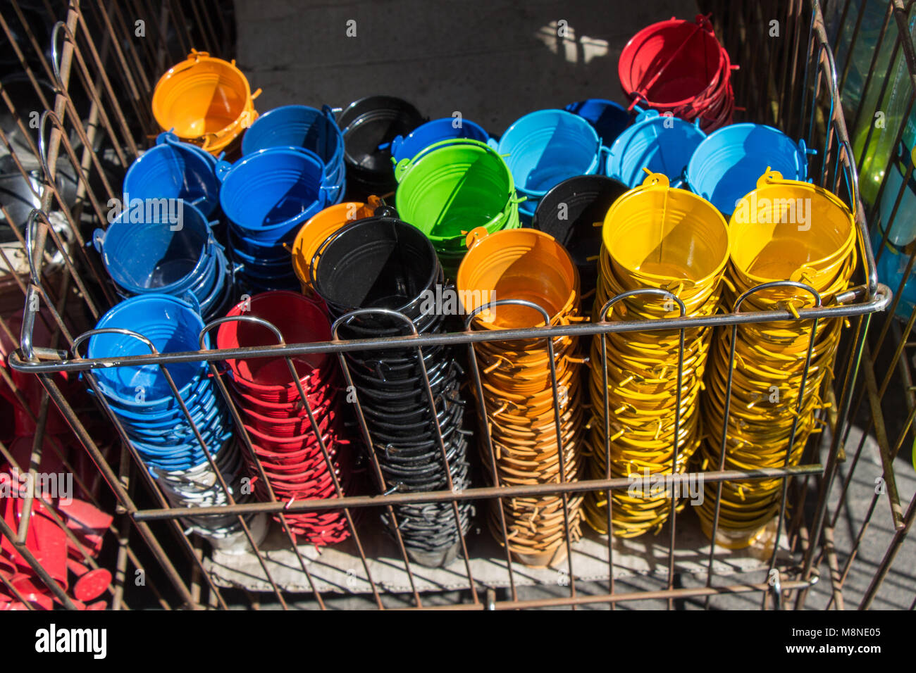 Little set of buckets of various colors in a market place Stock Photo ...