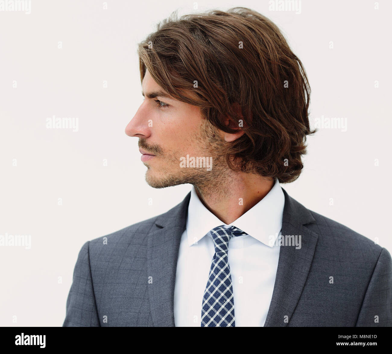 Handsome young business man looking away Stock Photo - Alamy
