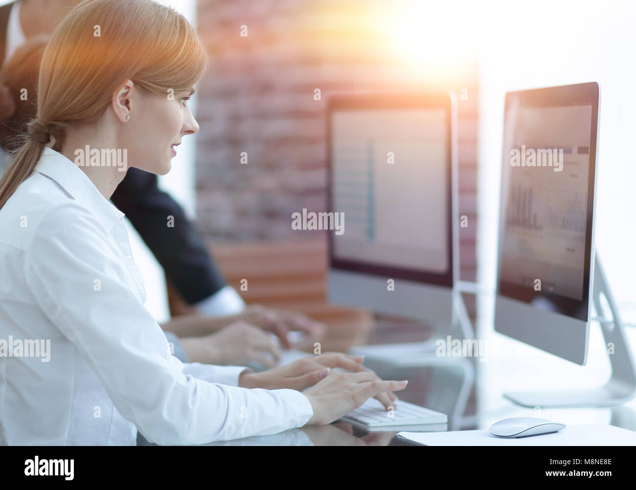 employees working on personal computers with financial data Stock Photo ...