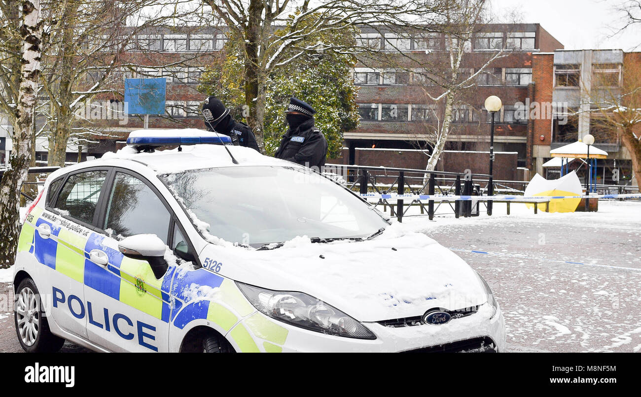 Police officers face the cold weather at the scene in The Maltings ...