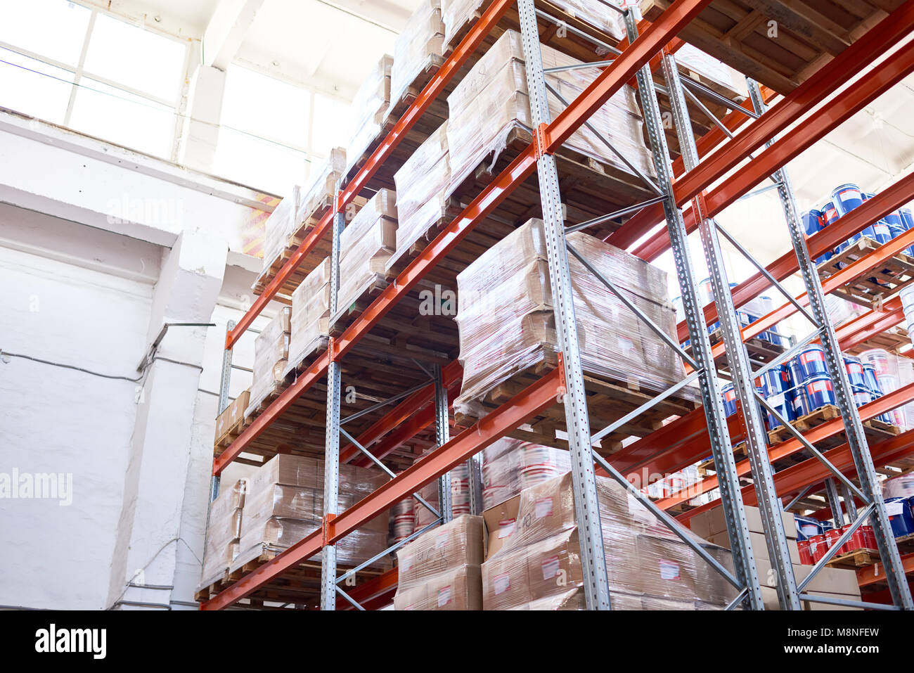 Low angle view at tall storage shelves with packed goods in warehouse ...