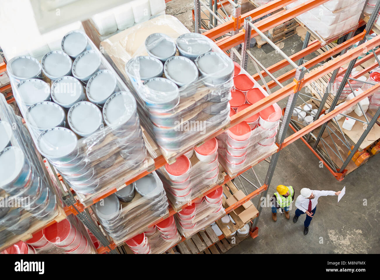 Top view background image of tall shelves in modern warehouse with two ...