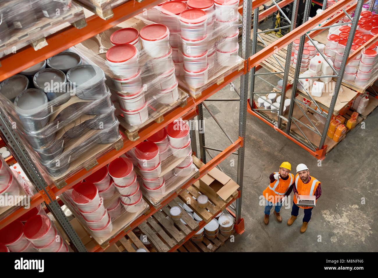 High angle background image of tall shelves in modern warehouse with ...