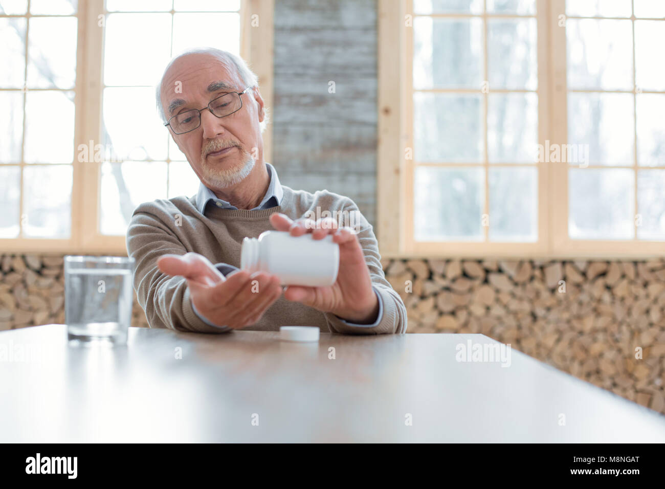 Old man taking his medication hi-res stock photography and images - Alamy