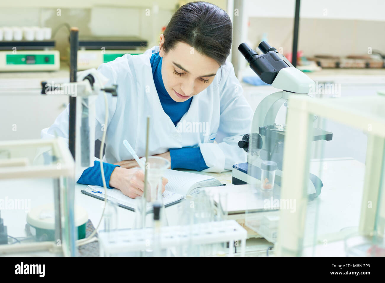 Doctor sitting desk taking notes hi-res stock photography and images ...