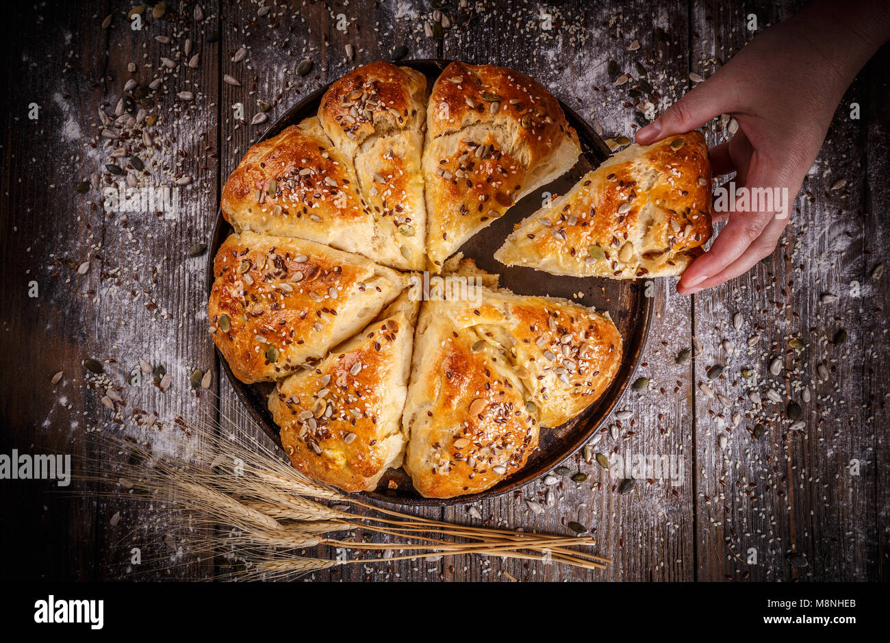 Fresh breakfast triangle buns with seeds on wooden background Stock ...