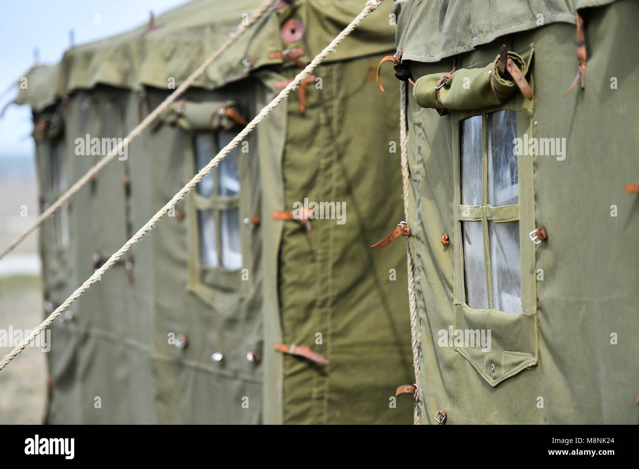 Detail with the exterior of a green military tent Stock Photo - Alamy