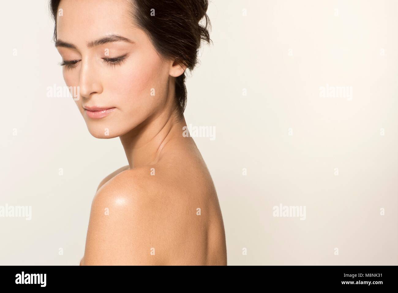 MODEL RELEASED. Young woman looking down, side portrait Stock Photo - Alamy