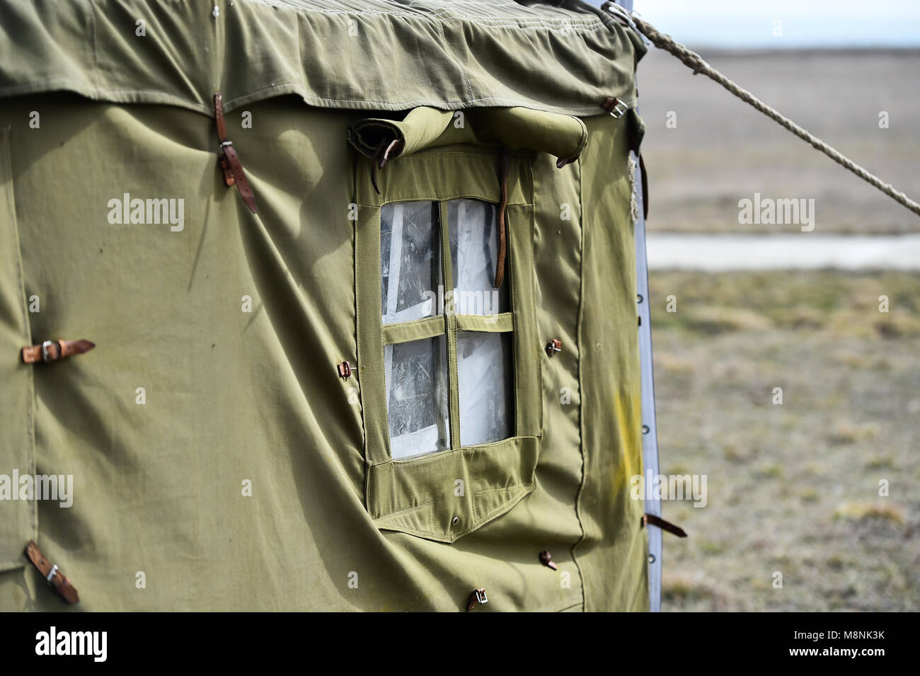Detail with the exterior of a green military tent Stock Photo - Alamy