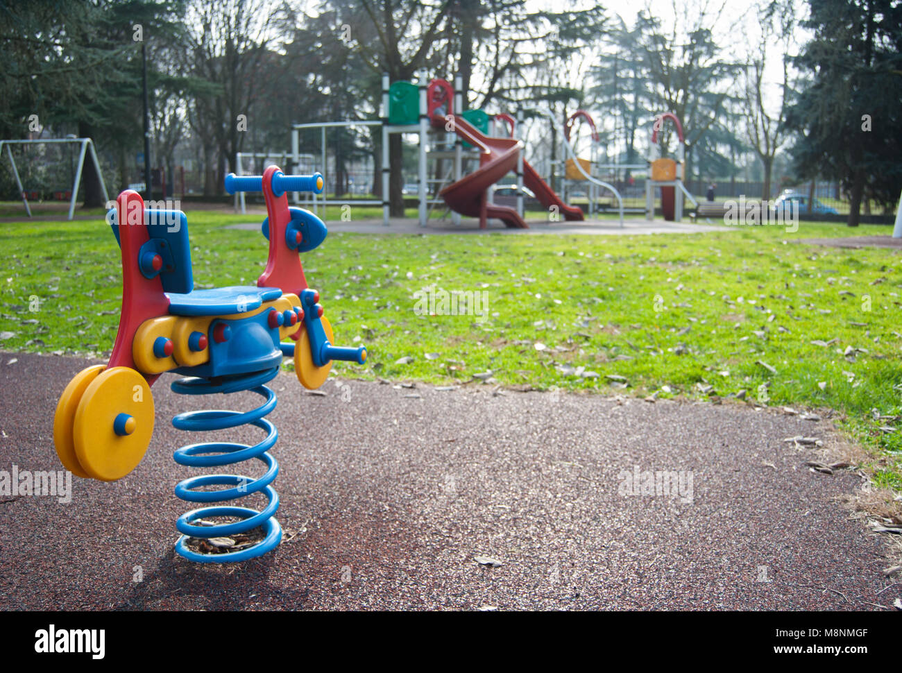 Metal spring with colorful motorcycle for children Stock Photo - Alamy