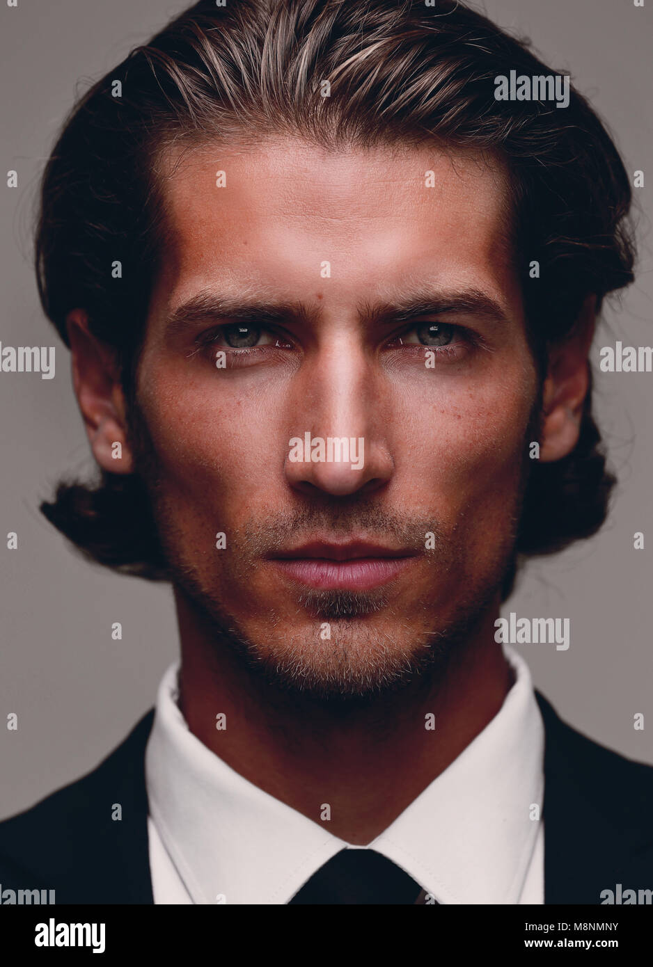 closeup face of responsible business men on a grey background Stock ...