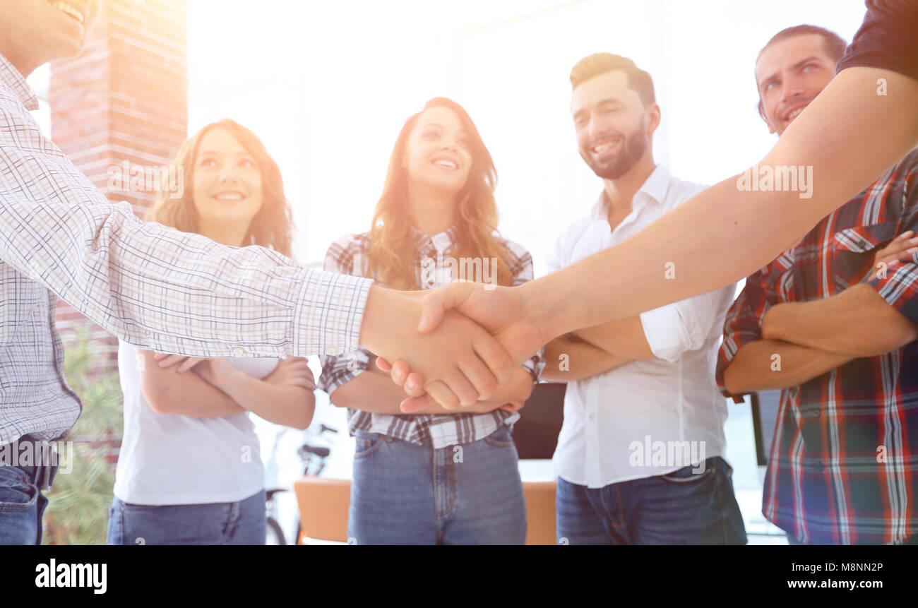 closeup of handshake business people on the background of the creative ...
