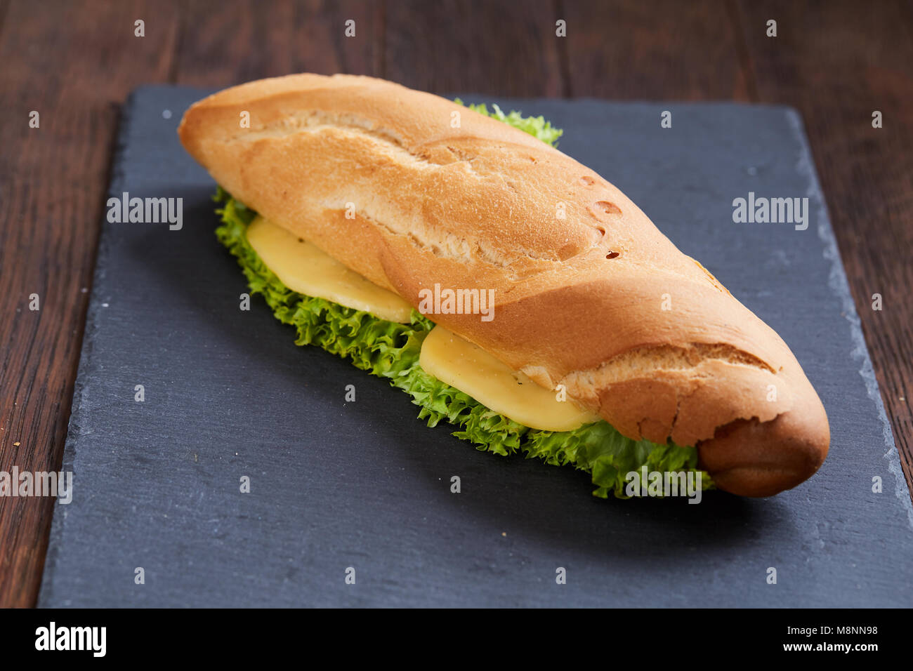 Fresh and tasty submarine sandwich with cheese and vegetables on ...