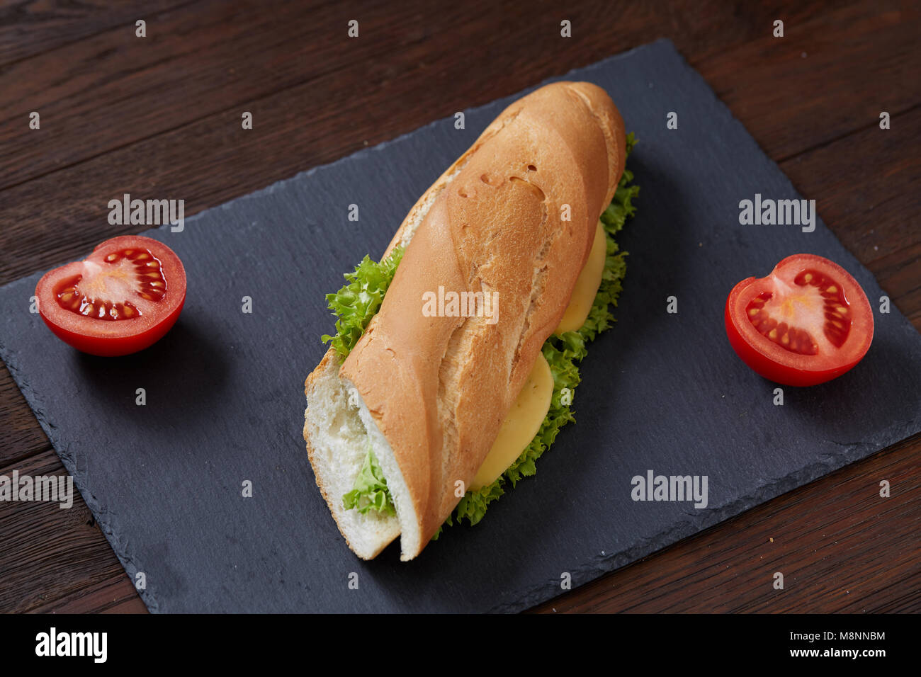 Fresh and tasty submarine sandwich with cheese and vegetables on ...