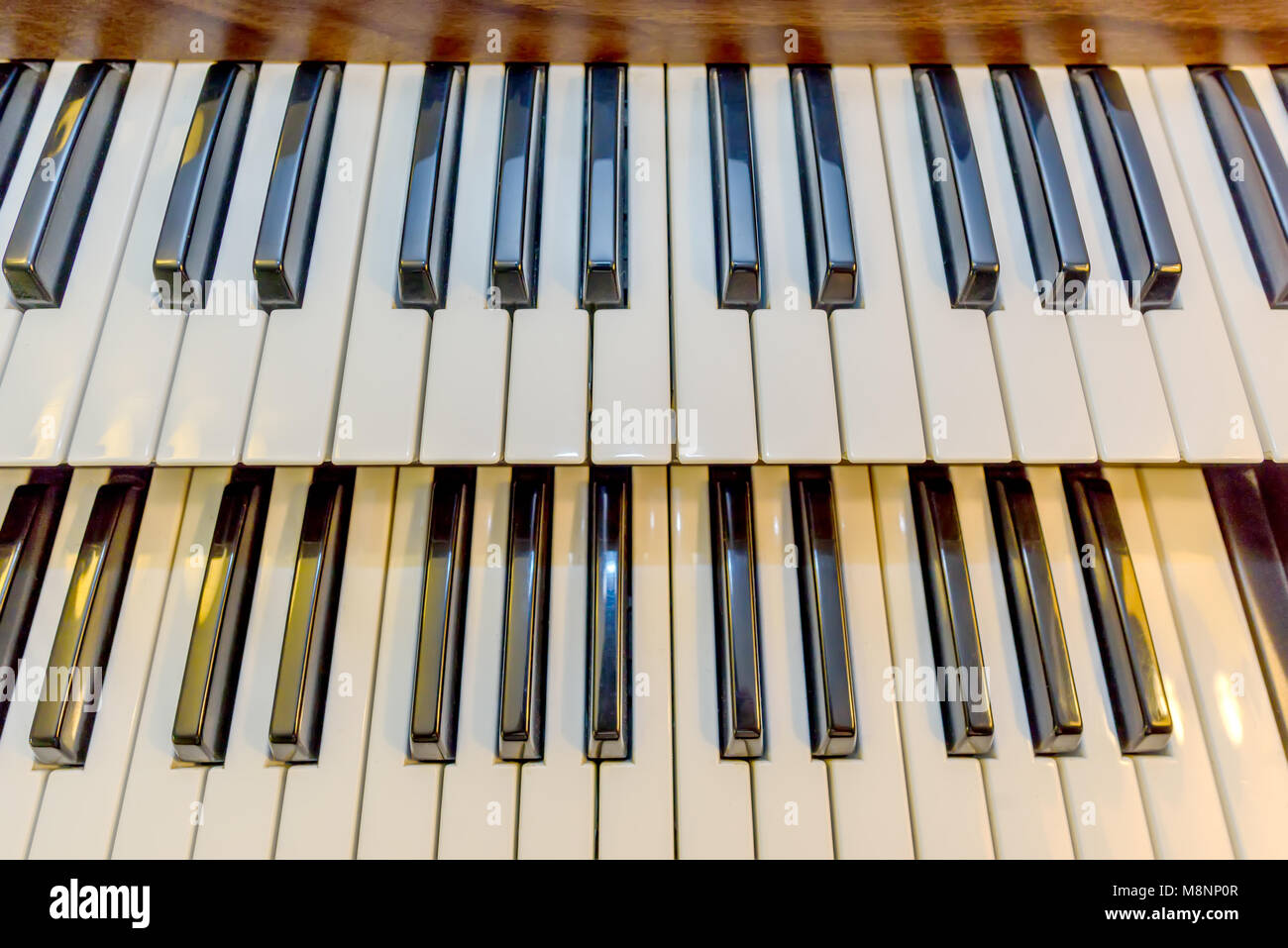 two rows of black and white keys of an old musical instrument, an organ ...