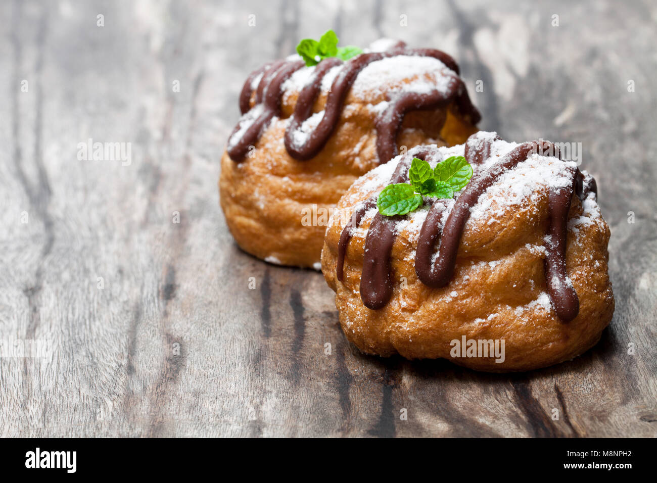 Belgian chocolate choux buns on wooden table Stock Photo - Alamy