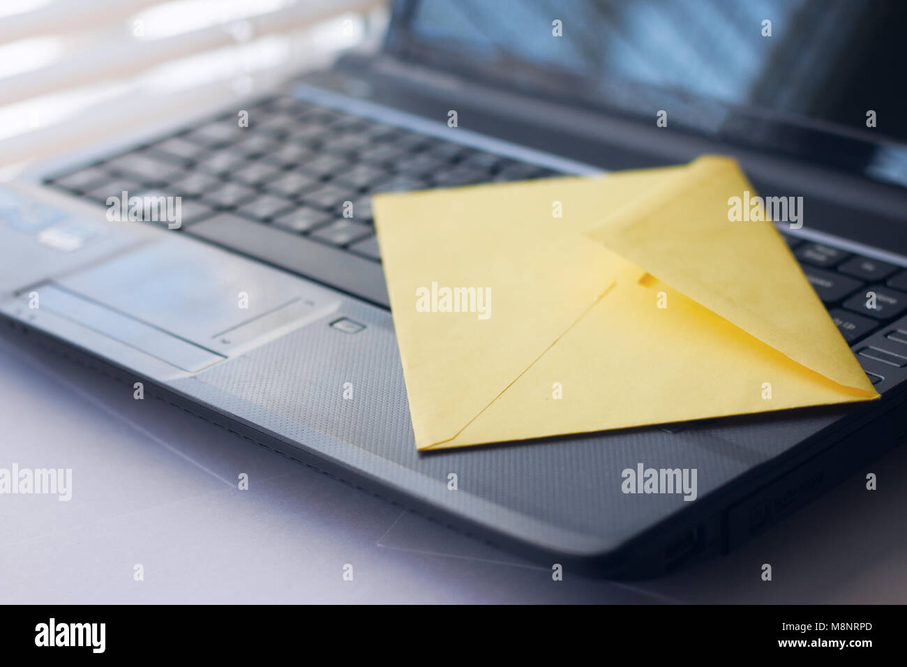 yellow envelope for a letter is on the laptop . email letter concept ...