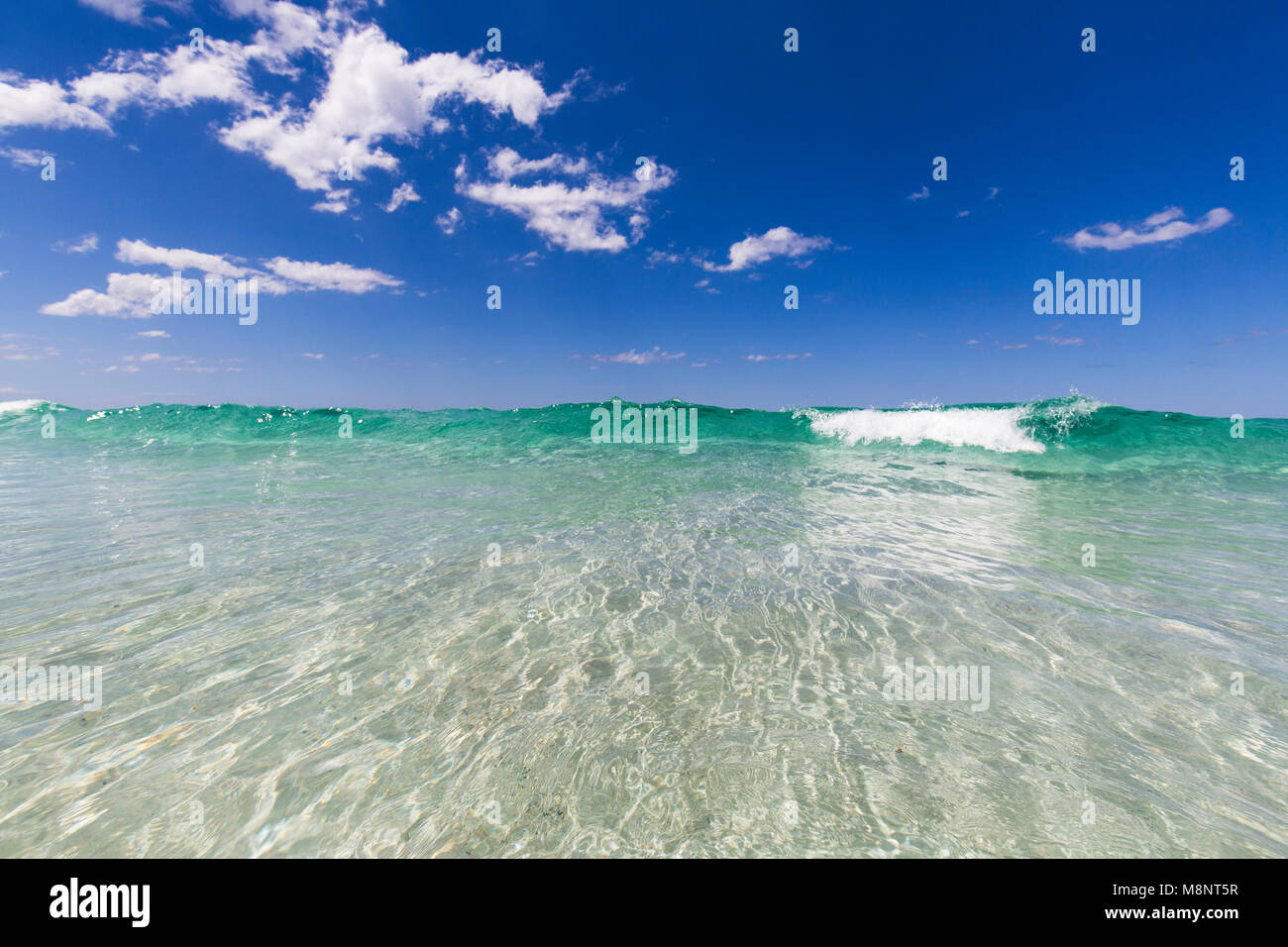 Clear turquoise Ocean water with blue sky Stock Photo - Alamy