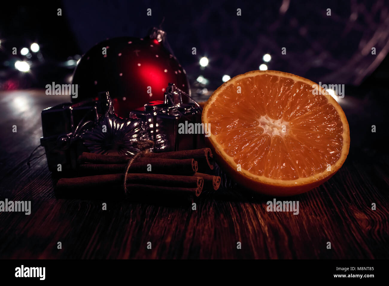 With orange Christmas ball and cinnamon.Citrus for guests. Treat Stock ...