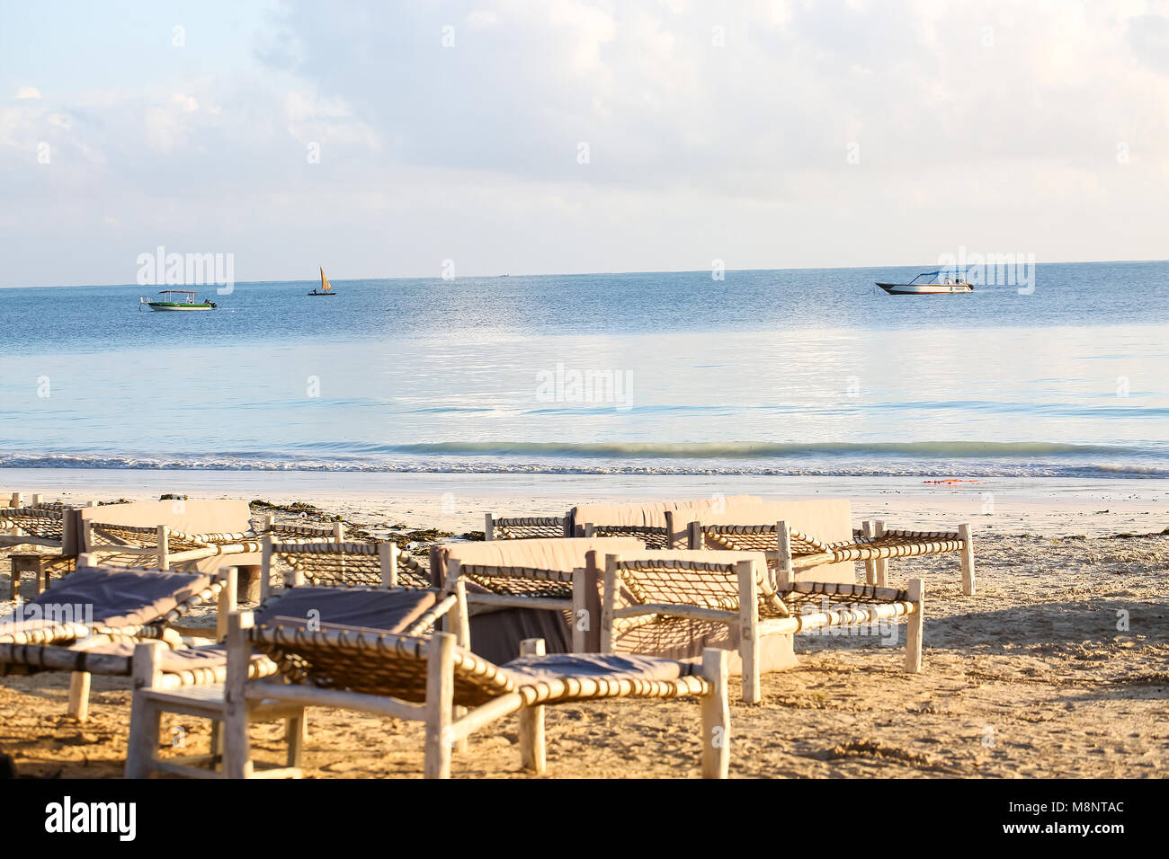 Beach with sun loungers and a place for rest at sunset Stock Photo - Alamy
