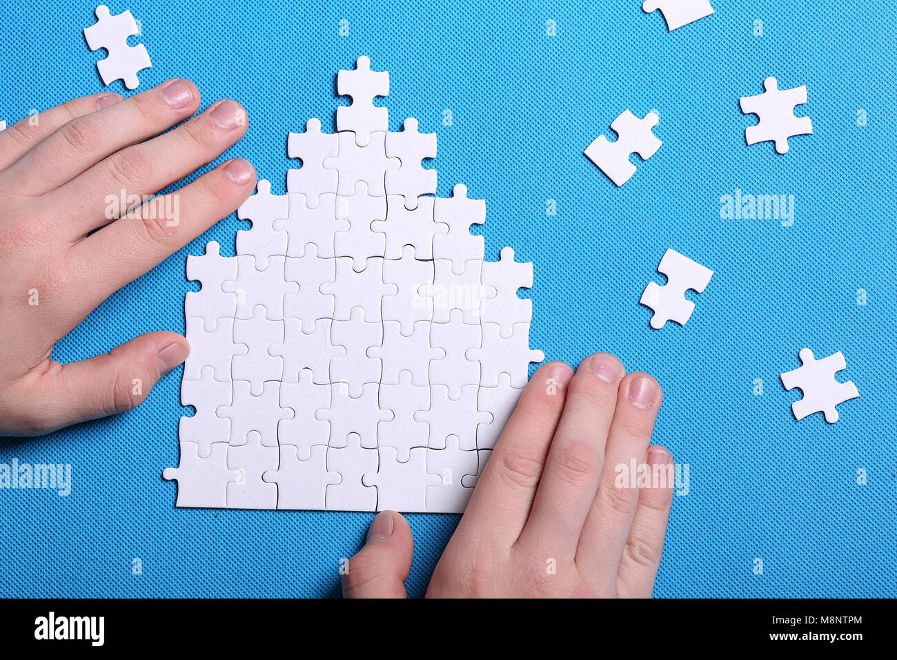 White details of a puzzle on blue background. A puzzle is a puzzle from ...