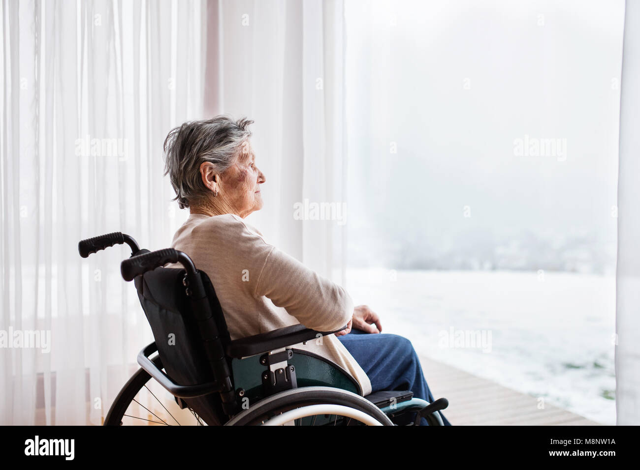 Senior woman in wheelchair at home Stock Photo - Alamy