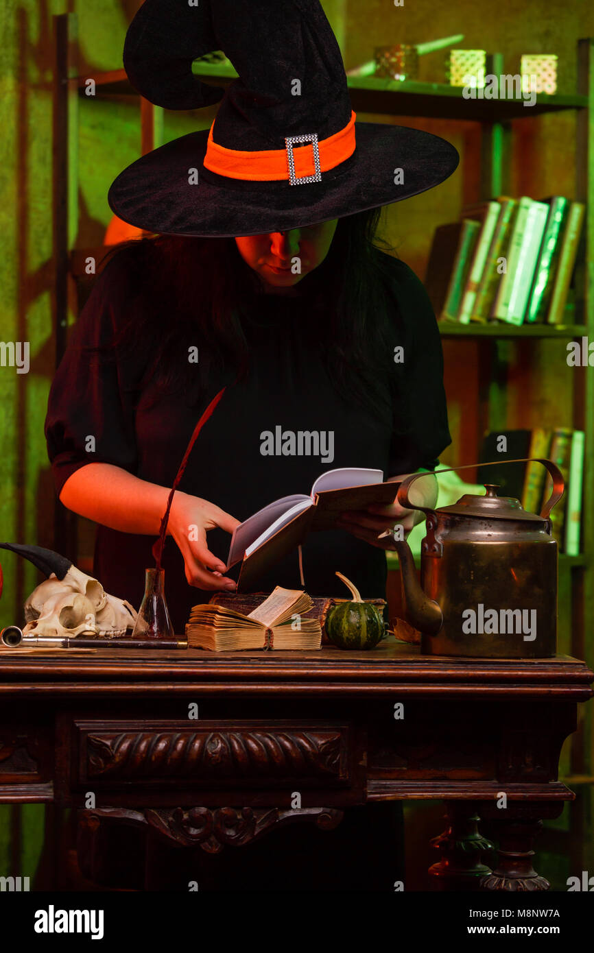 Photo of witch with spell book Stock Photo - Alamy