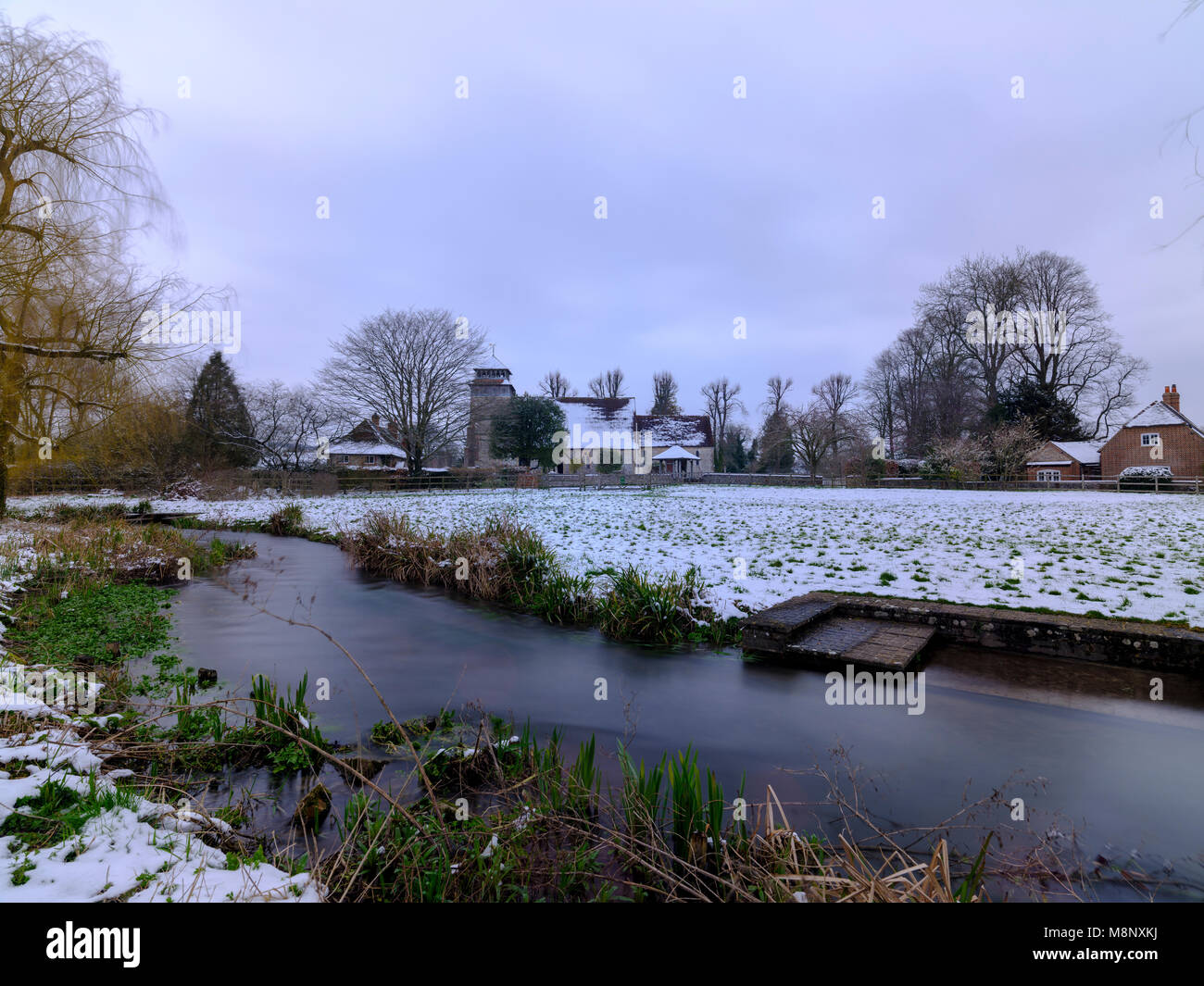 Spring snow scene of St Andrew's Church in Meonstoke in the Meon Valley ...