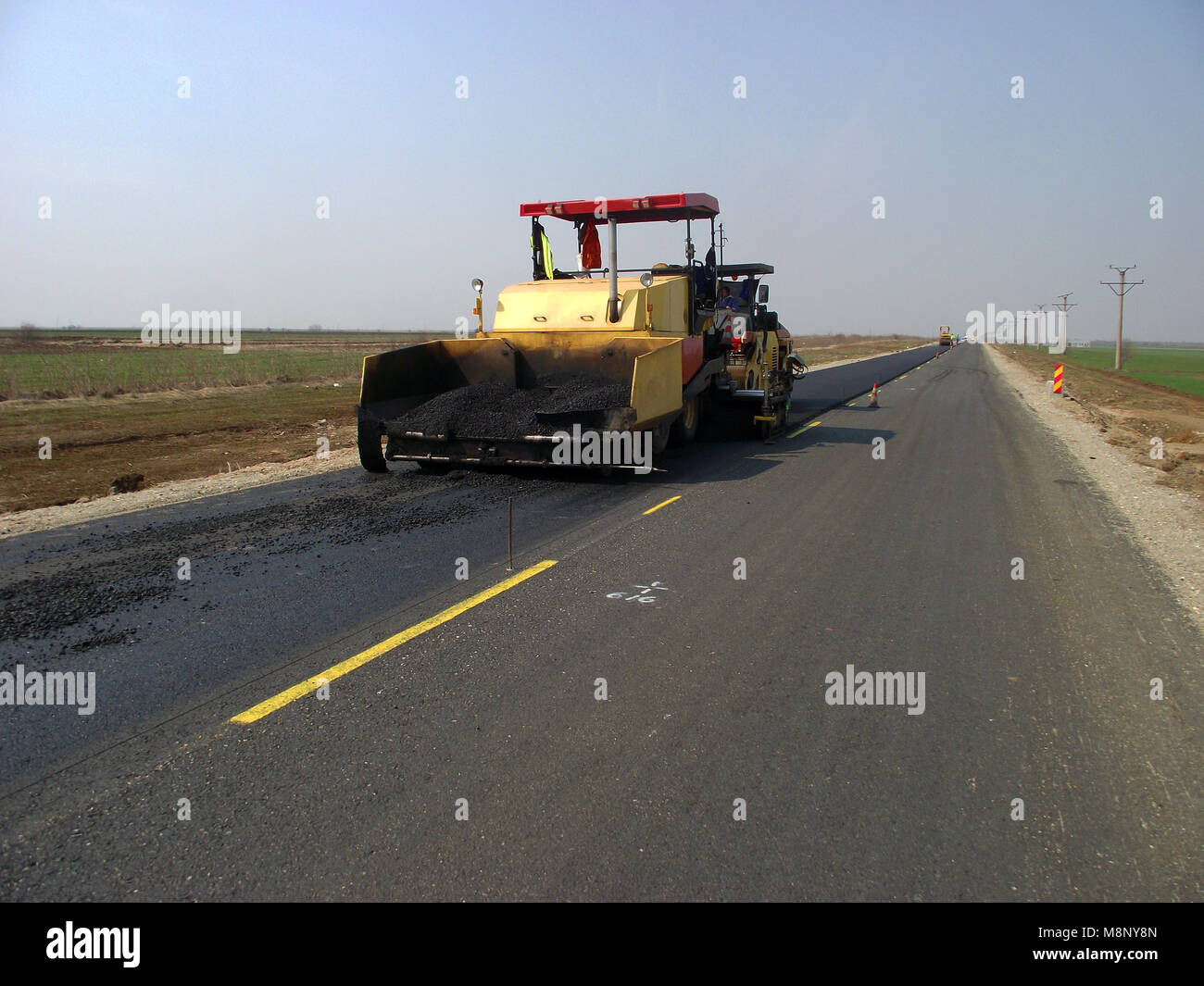 Machinery leveling of the bitumen Stock Photo - Alamy