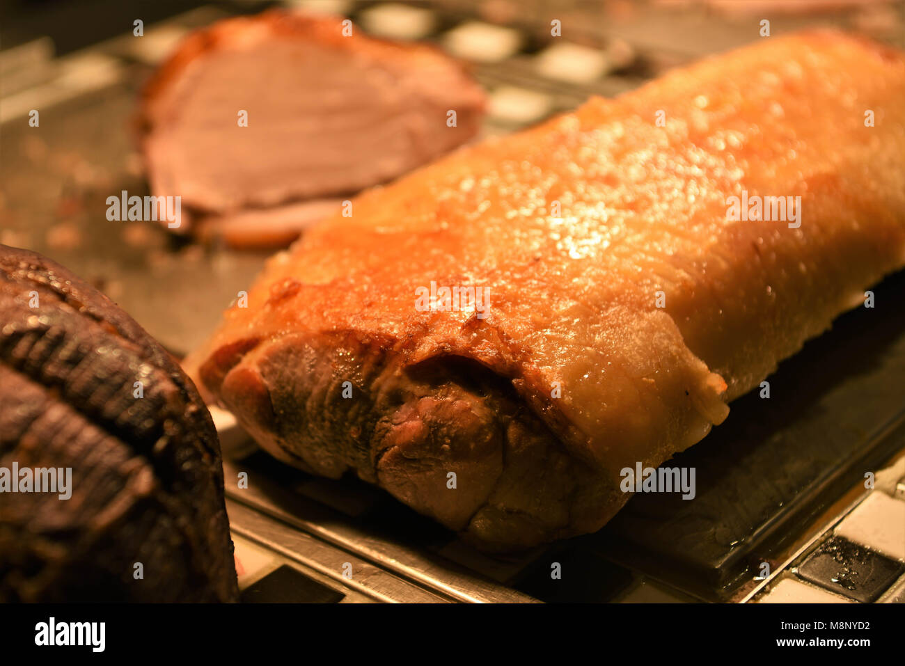 food with whole roast joint of pork belly and a portion carved Stock ...